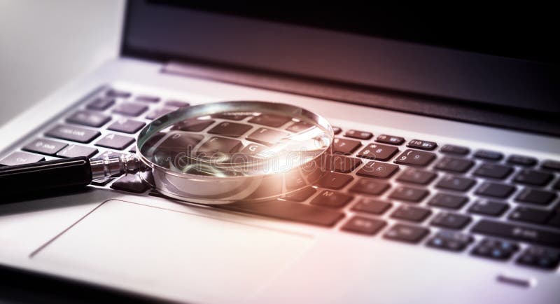 Magnifying Glass on Laptop Keyboard Searching the Internet for Online ...