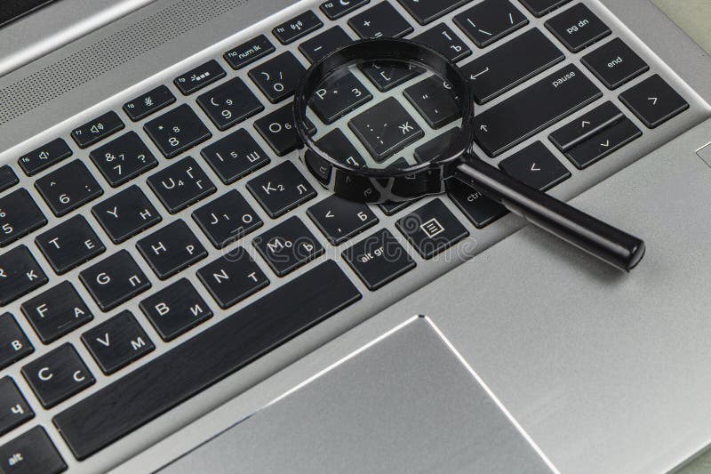 Magnifying Glass on a Laptop Keyboard Showing Different Characters and ...