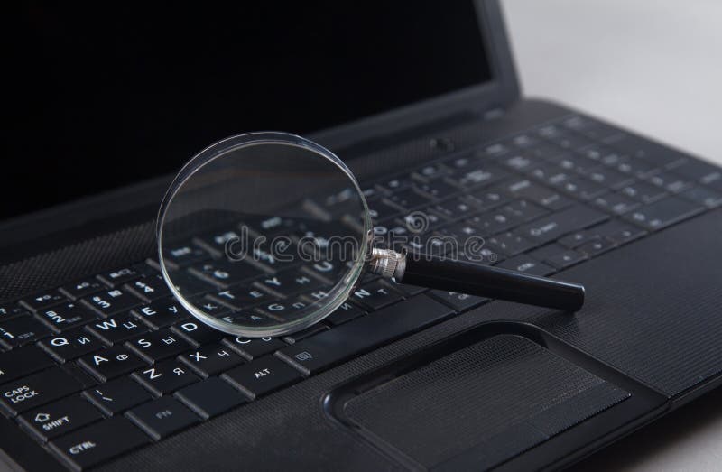 Magnifying Glass is Located on the Keyboard. Black Color Computer and ...