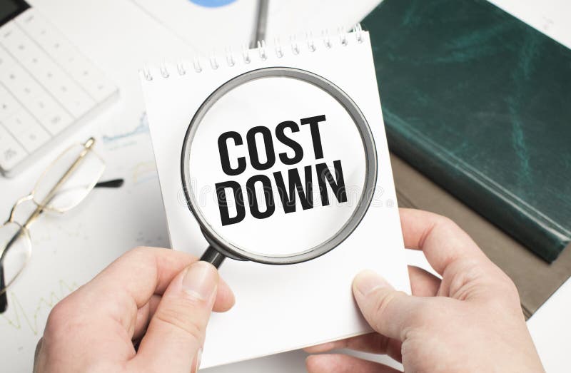 Magnifying Glass Loupe with Sign Cost Down on the Paper Notepad on the ...