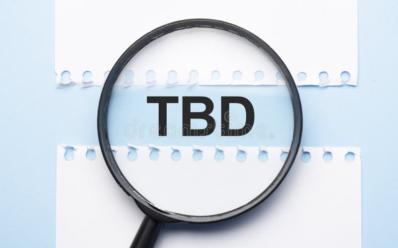 Magnifying Glass Loupe with Sign Tbd between Two Paper Sheets on the ...