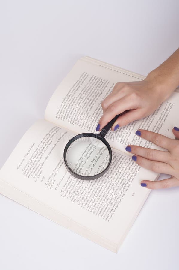 Magnifying glass over book stock image. Image of article - 28335279