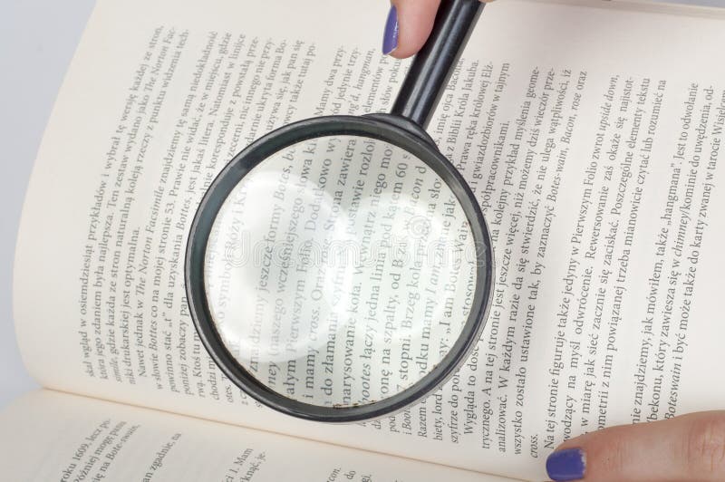 Magnifying glass over book stock photo. Image of magnifier - 28335304