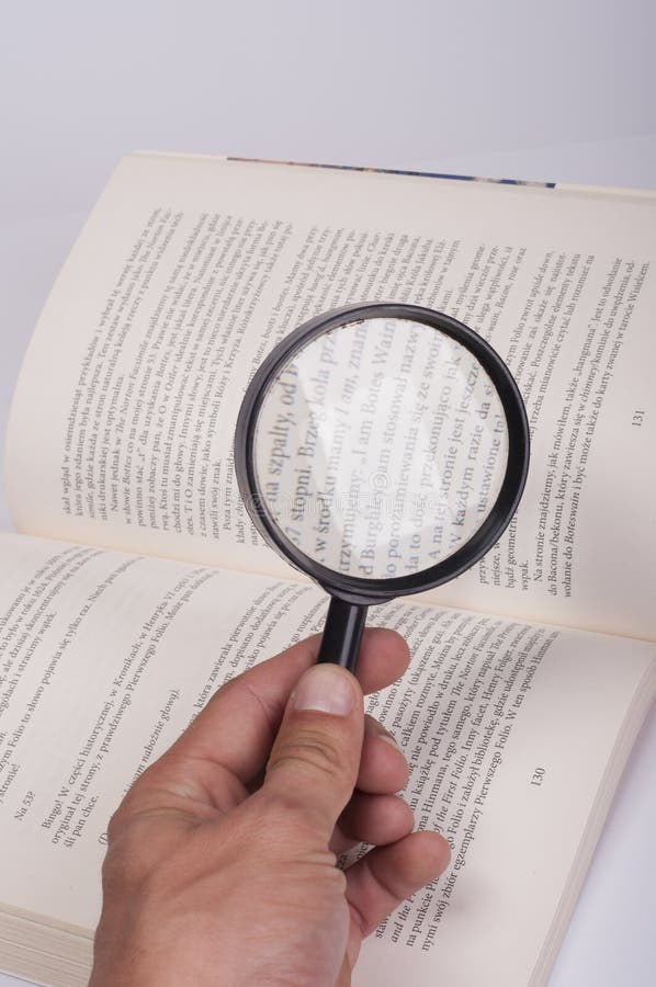 Magnifying glass over book stock photo. Image of magnifier - 28335304