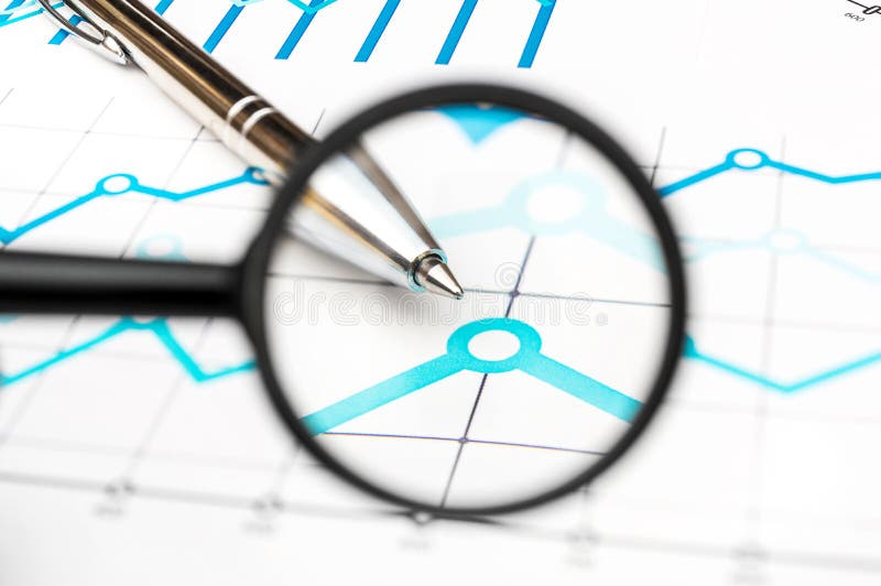 Magnifying Glass Over Pen, Which Pointing on Financial Graph Stock ... Magnifying Glass Over Pen, Which Pointing on Financial Graph Stock ...