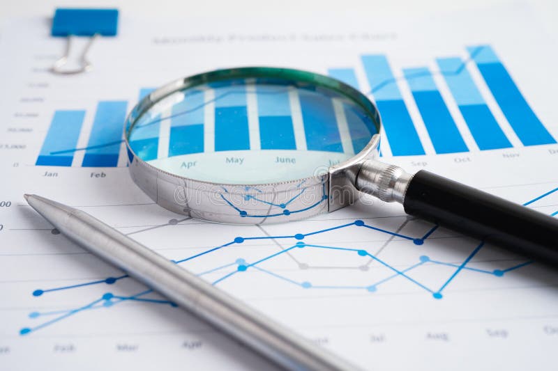 Magnifying Glass with Pan on Economy Graph in Business Stock Image ...