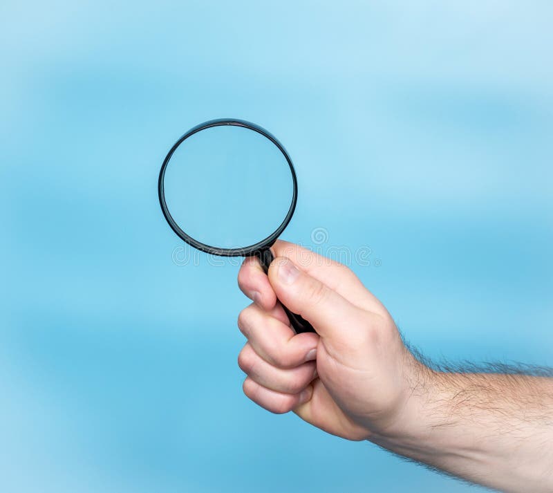 A Magnifying Glass in a Person S Hand, an Object in a Person S Hand is ...
