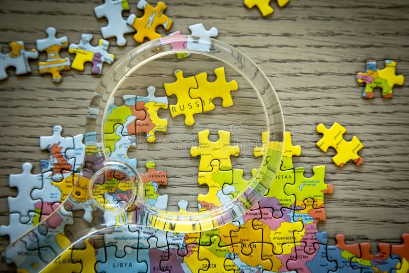 A Magnifying Glass on Russia in a World Map Puzzle with Puzzle Pieces ...