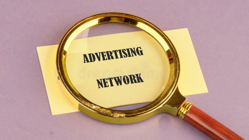 A Magnifying Glass Sits on Yellow Paper Featuring Bold Text that Reads ...