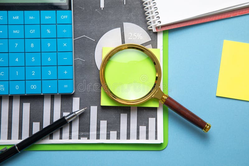 Magnifying Glass with a Sticky Note on Financial Graphs Stock Image ...