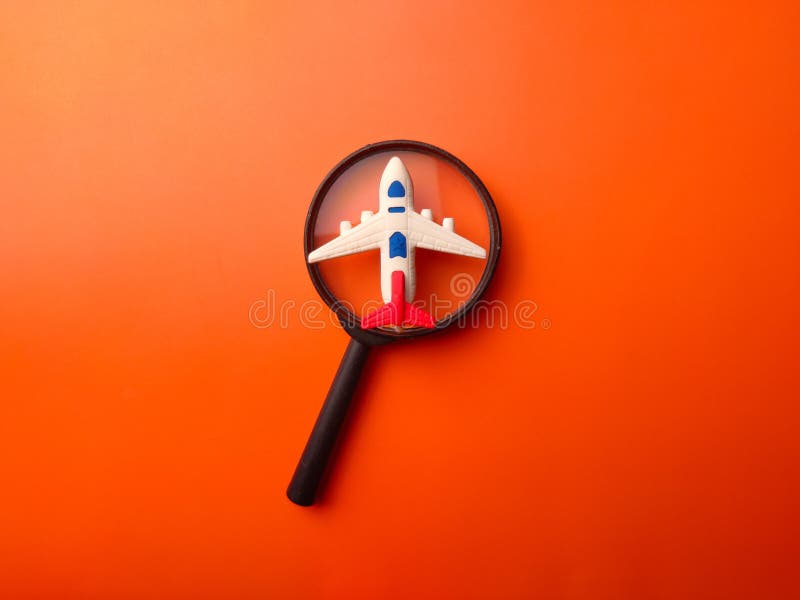 Magnifying Glass and Toy Plane on a Orange Background Stock Photo ...