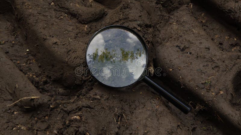 Magnifying Glass on a Tractor Track Stock Photo - Image of black ...