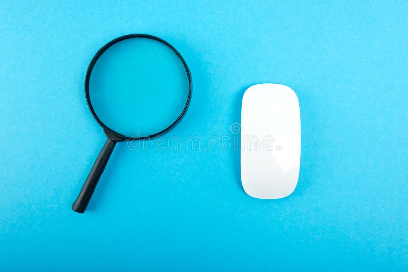 Magnifying Glass and White Pc Mouse on Blue Table. Stock Image - Image ...