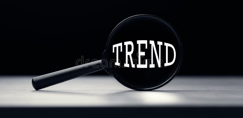 Magnifying Glass with the Word TREND on Table Stock Photo - Image of ...