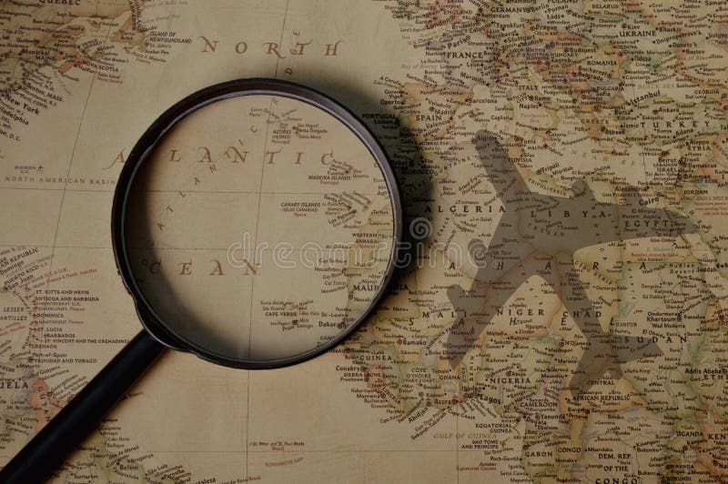 Magnifying Glass on World Travel Map with Airplane Stock Photo - Image ...