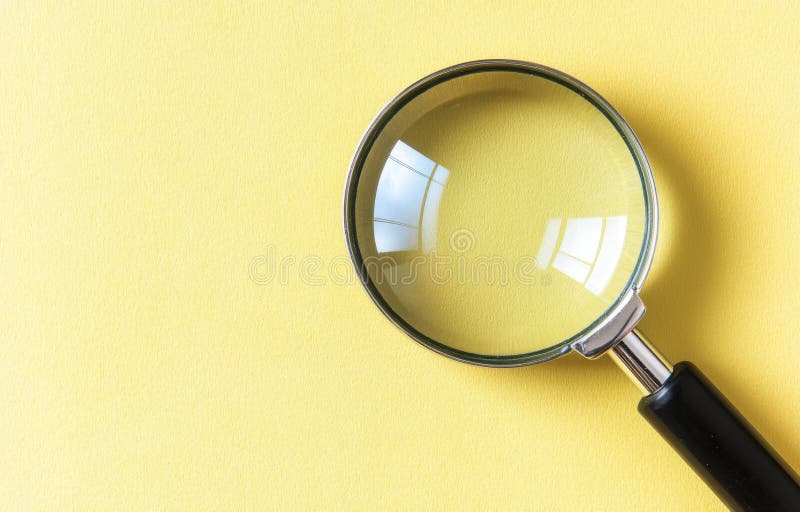 Magnifying Glass on Yellow Surface in Well-lit Environment Stock Image ...