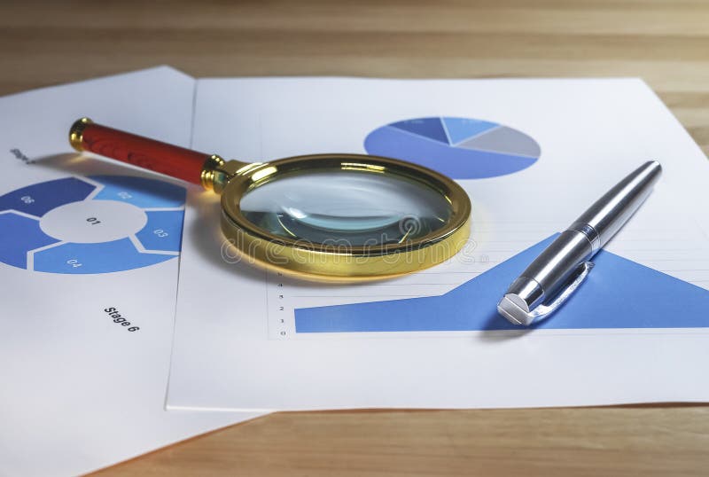 Magnifying Lens on Documents with Business Charts and Graphs Stock ...