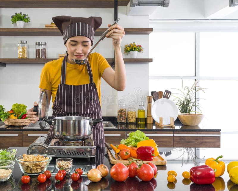 The Maid is Doing the Meat Stew in a Modern Kitchen Stock Photo - Image ...