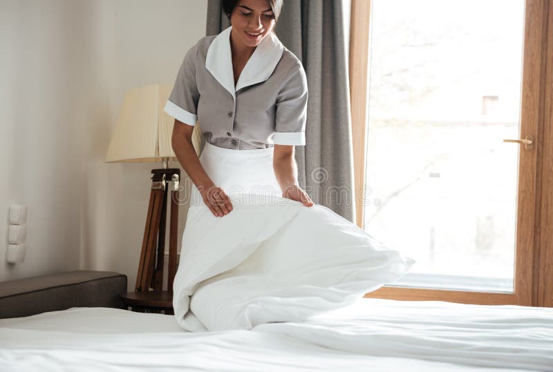 Maid Setting Up White Bed Sheet In Hotel Room Stock Image Image Of