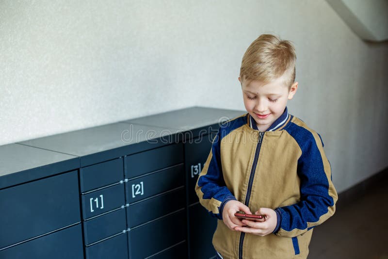 Boy Client Using Automated Self Service Post Terminal Machine or Locker ...