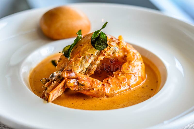 A Main Course of King Prawn Served in Bang Sauce with a Bun Stock Image ...
