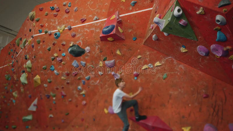 A Brave and Strong Boy Climber Trains Indoors in a White T-shirt Stock ...