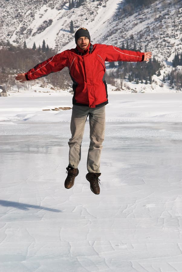 Main in Red Jumping on Winter Lake Stock Photo - Image of motion, lake ...