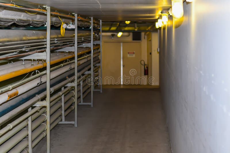Maintenance Hallway in an Industrial Building with Conduit Running Down ...