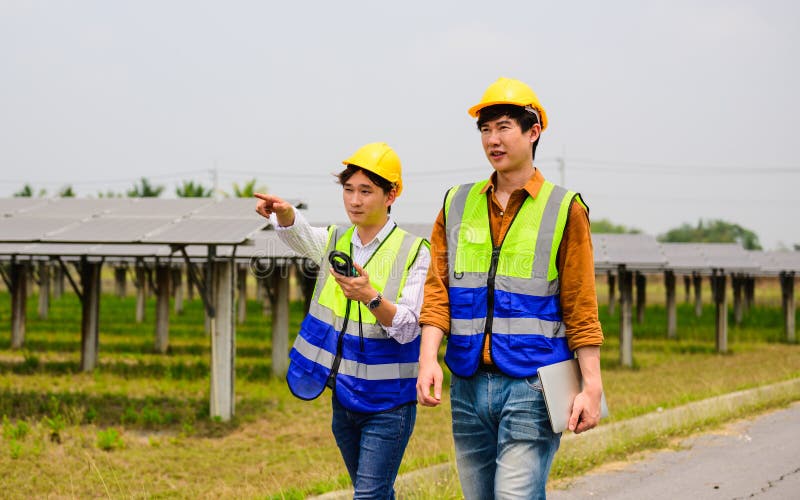 Happy Maintenance Engineer Checking and Maintaining Solar Panels System ...