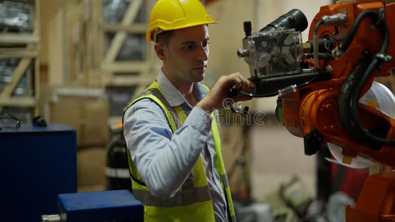 Maintenance Engineer with Robotic Arms at Industrial Factory Stock ...