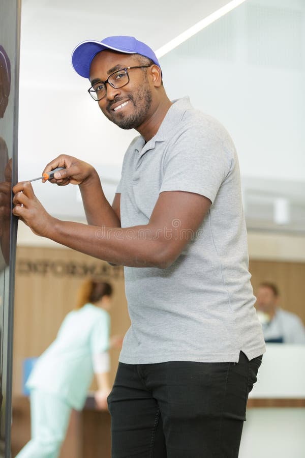 Maintenance Man Using Screwdriver in Hospital Stock Photo - Image of ...
