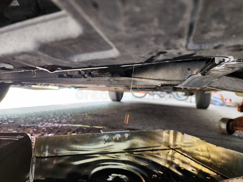 Maintenance Service by Using a Car Jack, Changing Engine Oil. Stock ...