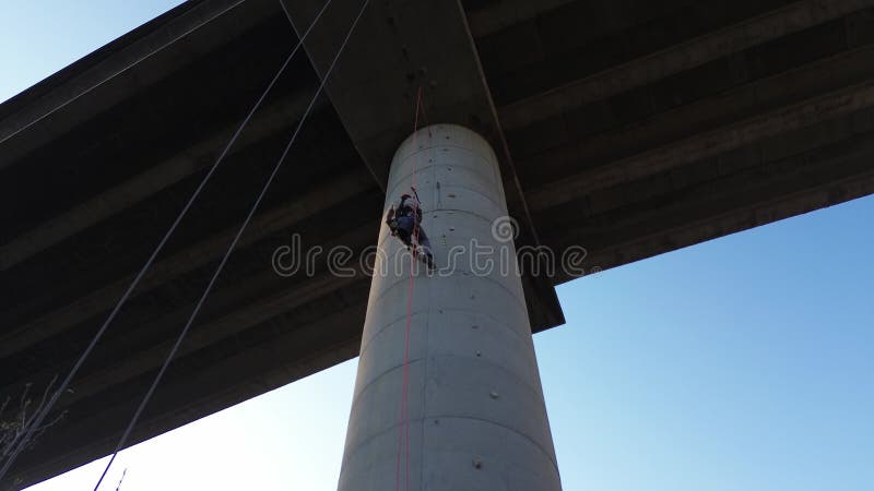 Technician Rappelling Down Bridge Pillar for Inspection Stock Footage ...