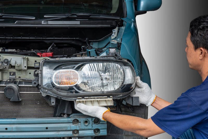 Mechanic with New Car Headlight in a Workshop Stock Photo - Image of ...