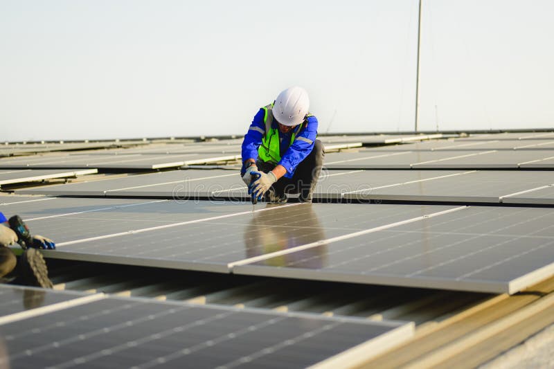 Maintenance Technicians Installing Solar Panels at Solar Cell Farm ...