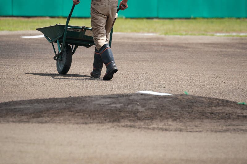 A Maintenance Worker on the Baseball Field for a Game. Stock Photo ...