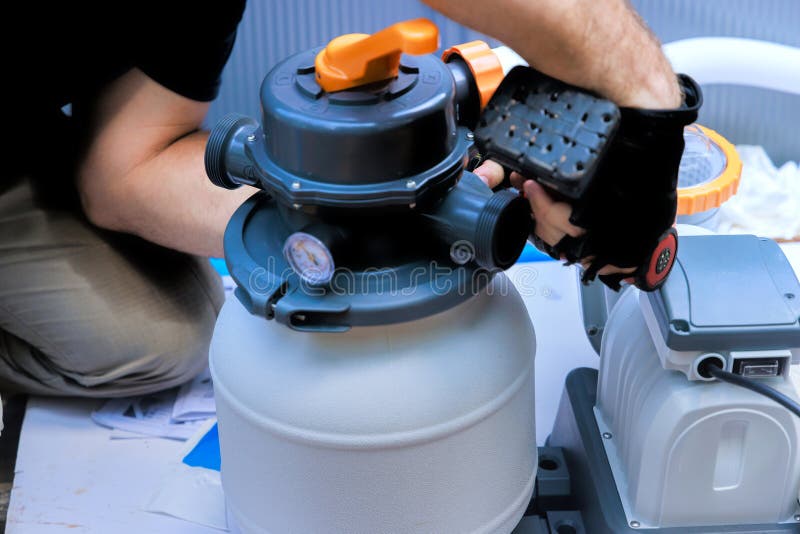 Maintenance Worker Service Assembles a Sand Filter System Tank ...