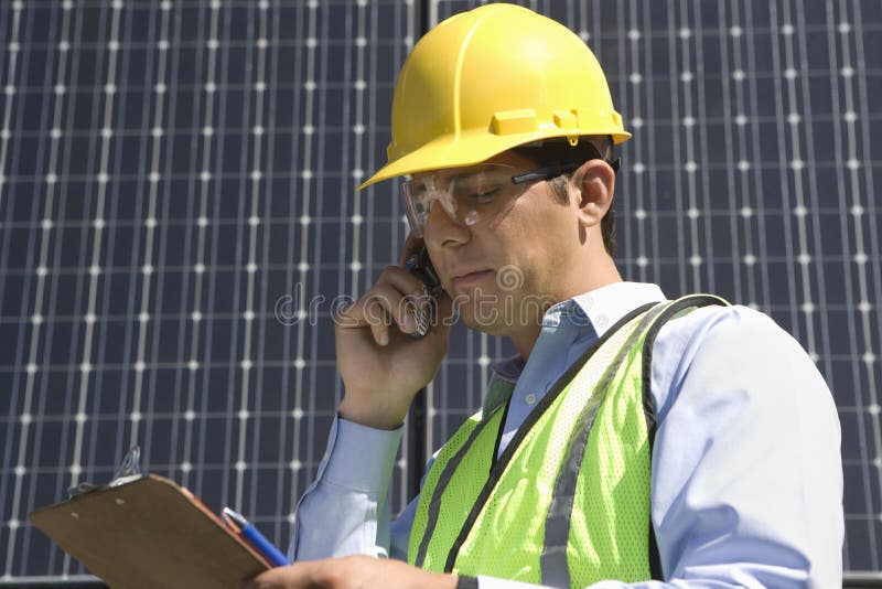 Maintenance Worker Using Cell Phone Near Solar Panels Stock Image ...