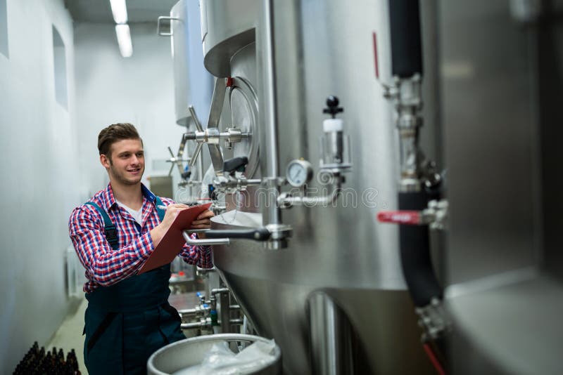Maintenance Worker Writing on Clipboard Stock Image - Image of ...