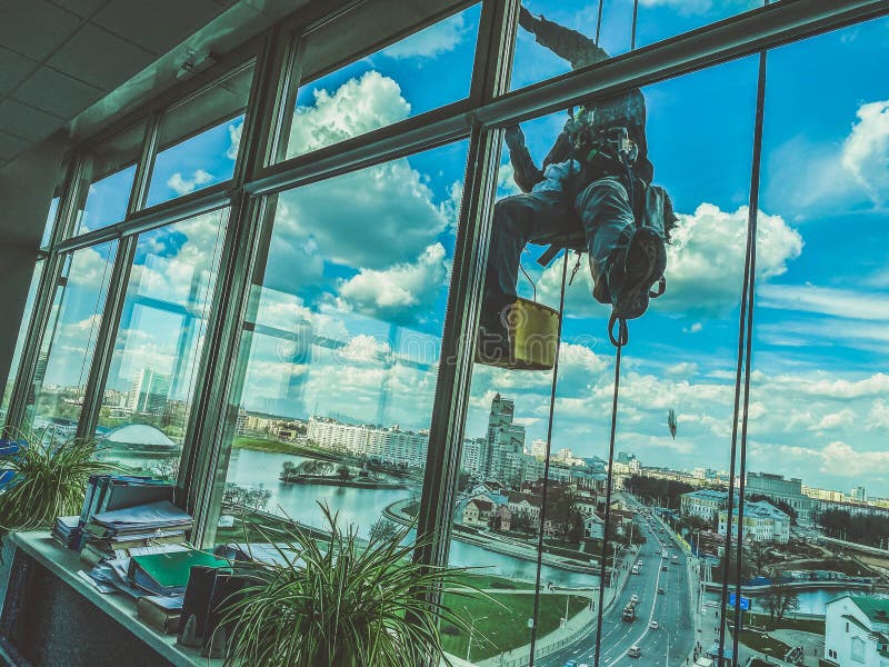 A Maintenance Workers Cleaning Windows on High Rise Stock Image - Image ...