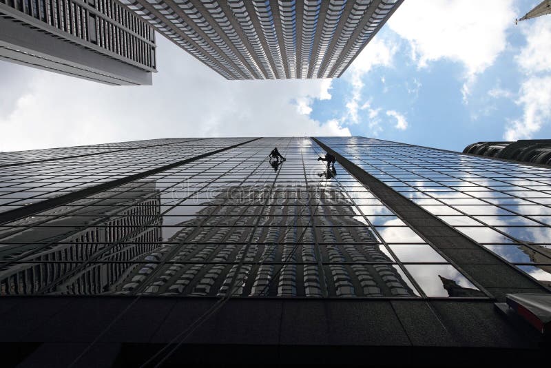 Maintenance Workers Climbing Outside a Skyscraper Stock Photo - Image ...