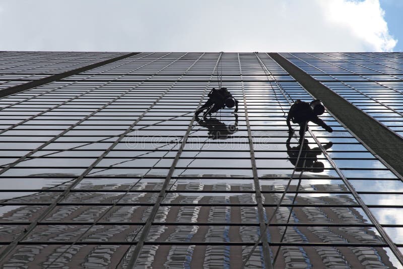 Maintenance Workers Climbing Outside a Skyscraper Stock Image - Image ...