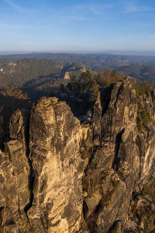 Majestic Cliffs Covered with Pine Trees Rise Above Dense Forest. View ...