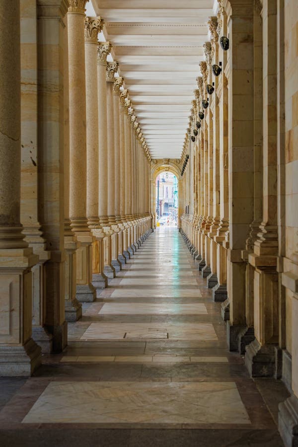 Majestic Corridor Lined with Stone Columns and Arched Ceiling in Sunlit ...