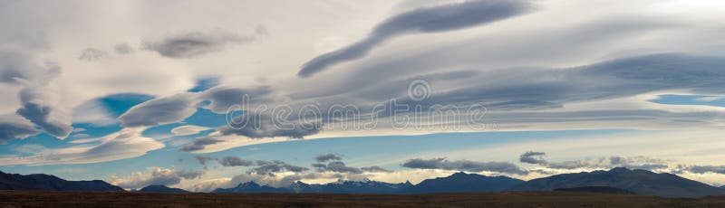 Dramatic Lenticular Clouds Hovering Over Mountain Range Stock Photo ...