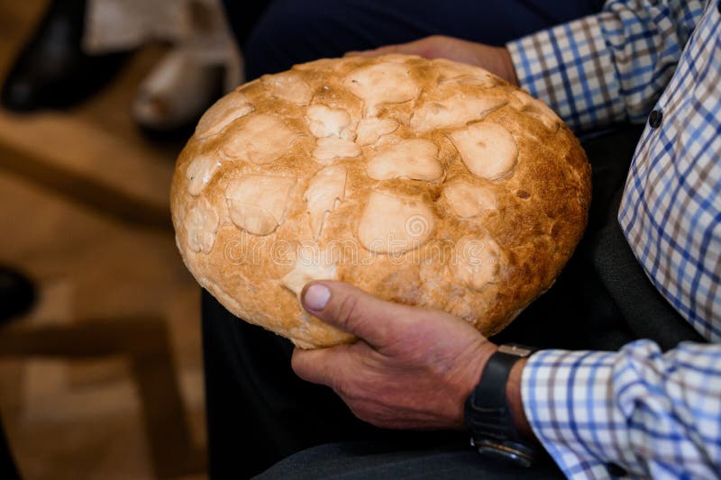 Majestic Round Loaf of Traditional Bread Held by a Person Stock Photo ...