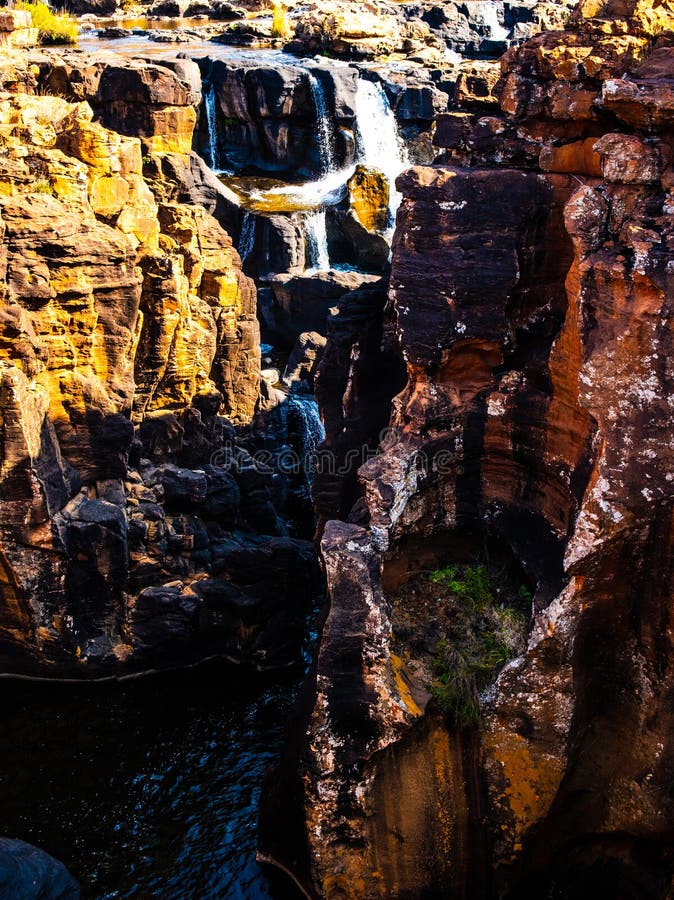 Majestic Waterfall Cascading Down the Side of a Mountain, Surrounded by ...