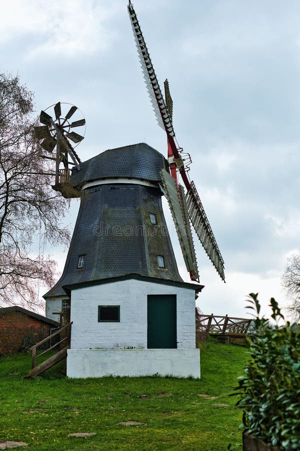 Majestic White Windmill in the Middle of a Lush, Green Field Stock ...