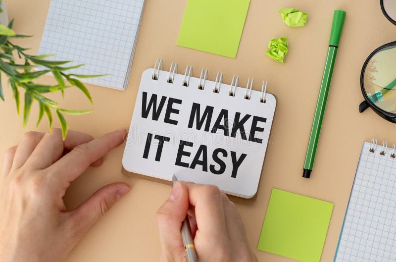 We Make it Easy Text in the Notebook on a Yellow Table. Top View ...