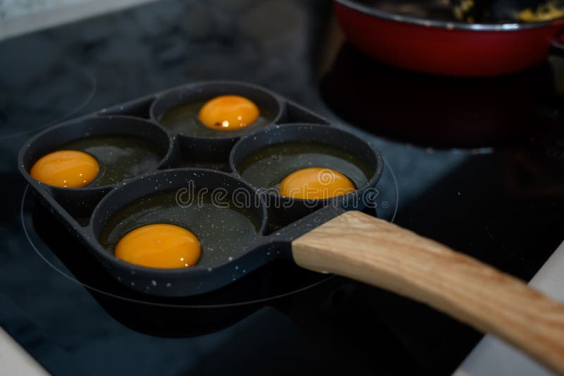 Make Fried Eggs on Black Frying Pan on Electric Stove for Breakfast ...